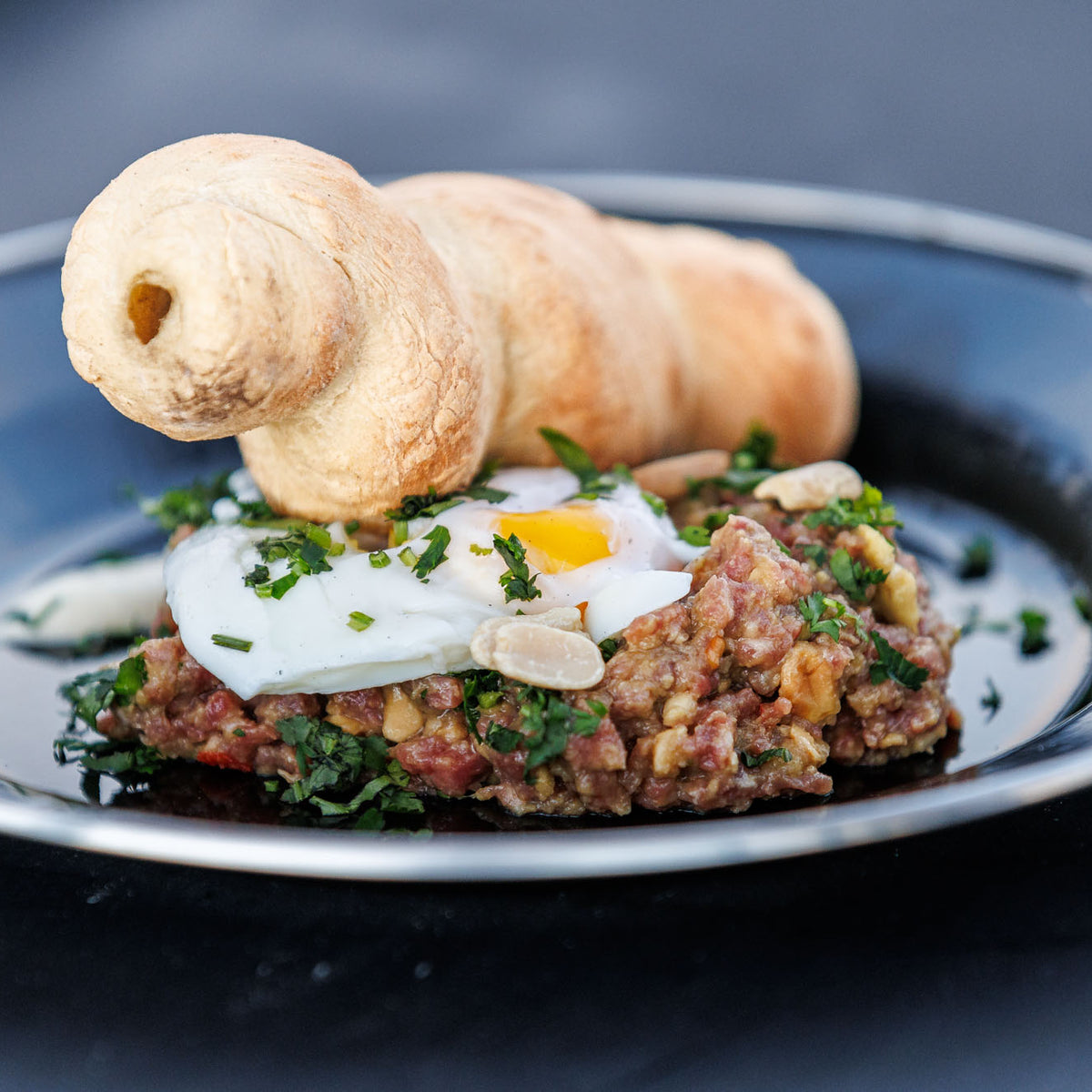 Stuffed stick bread with Asian beef tartare, poached egg and wasabi ma ...